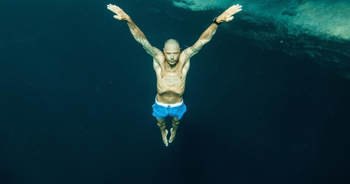 man diving underwater
