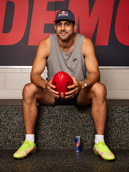 Christian Petracca poses in the Melbourne Demons locker room