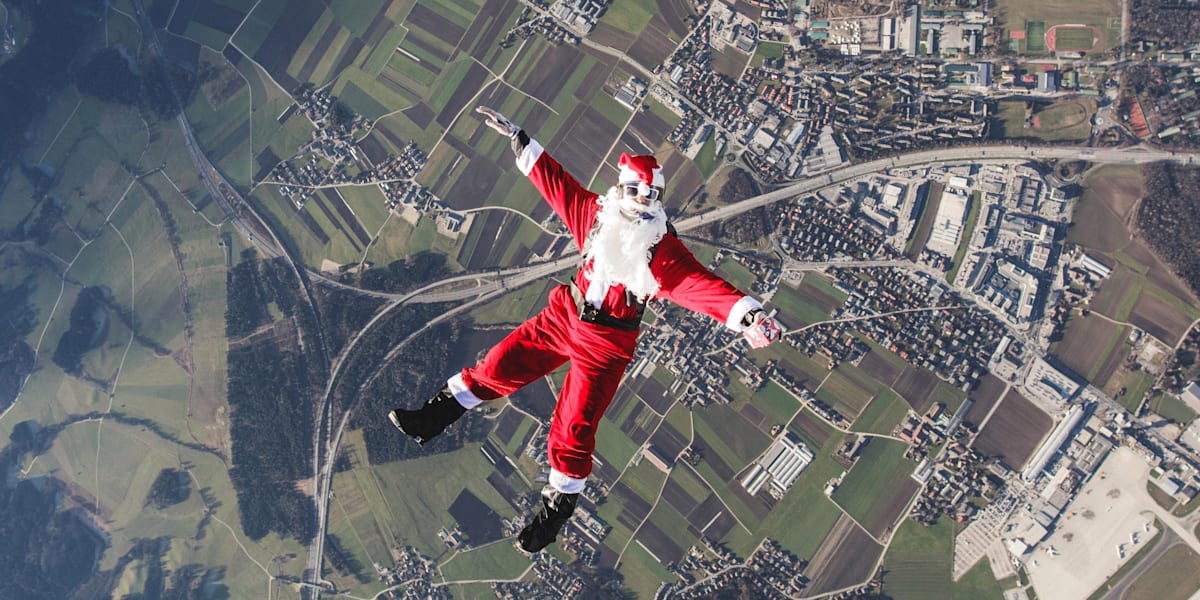Watch Santa deliver some gifts while skydiving Red Bull