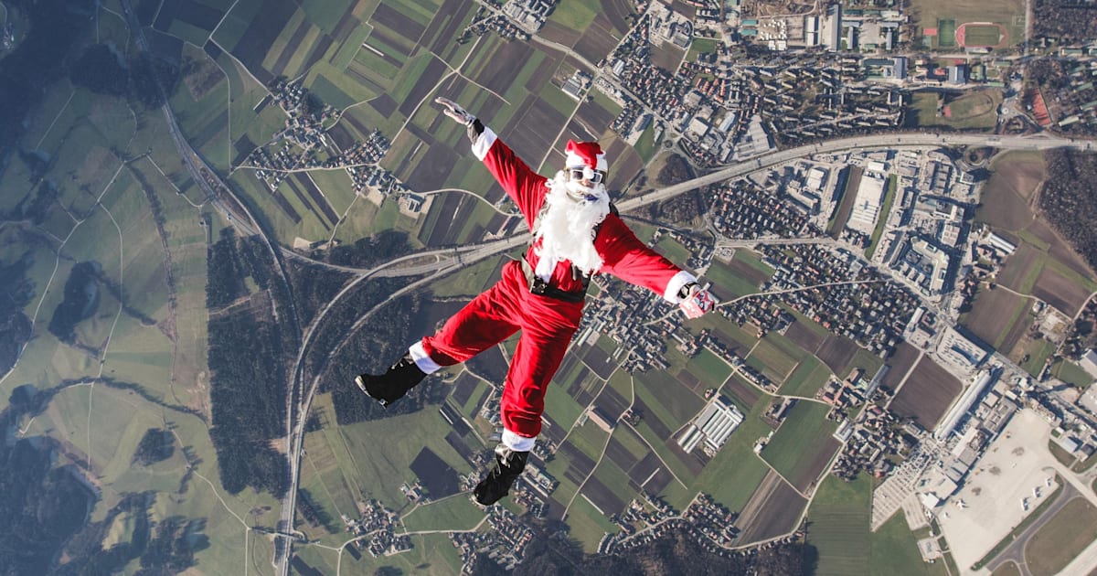 Watch Santa deliver some gifts while skydiving Red Bull