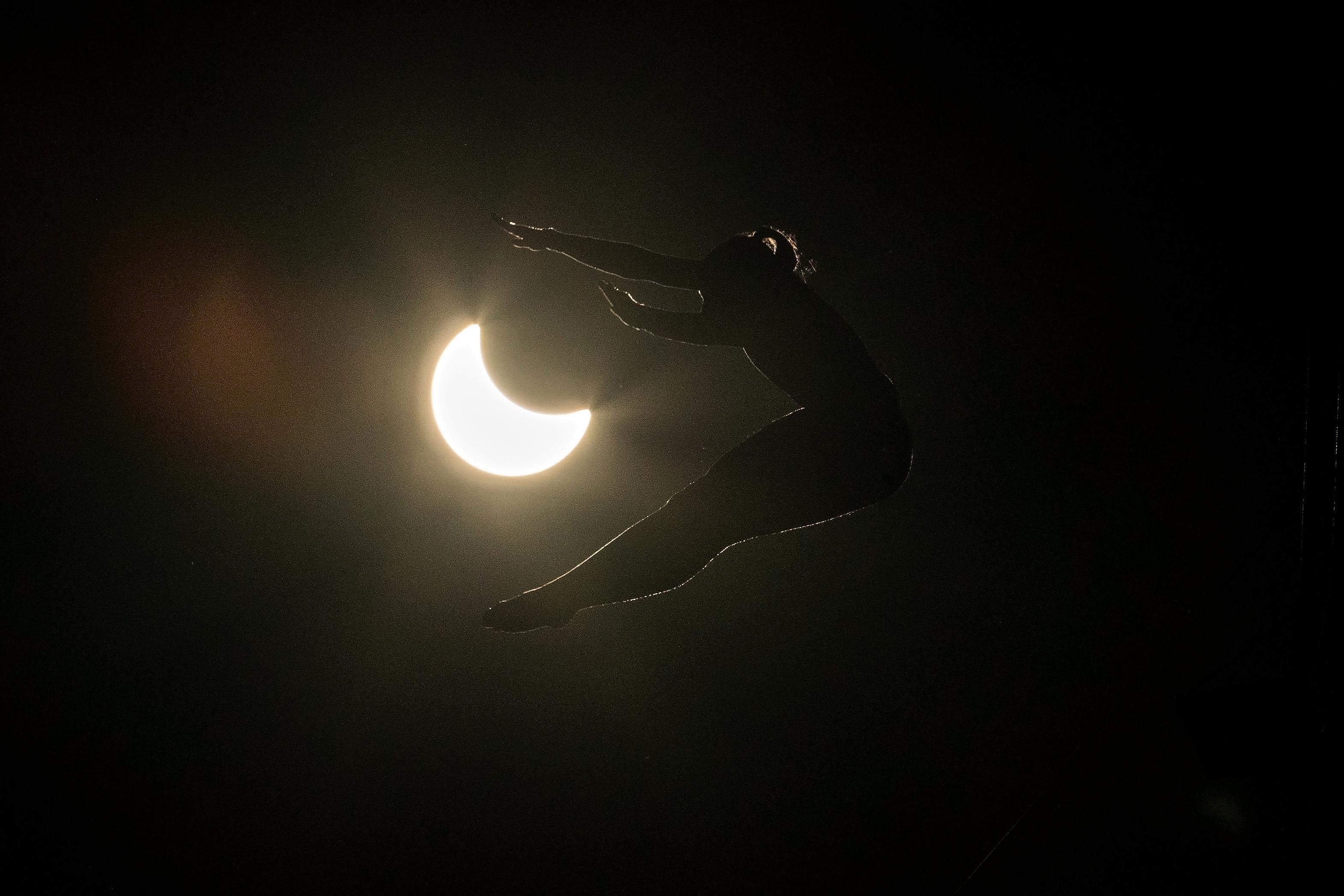 Solar eclipse photos: Cliff diving, highlining Red Bull